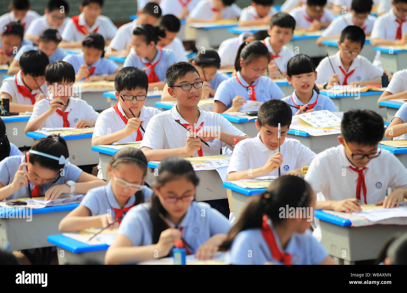 Young students calligraph Chinese characters during the opening ...