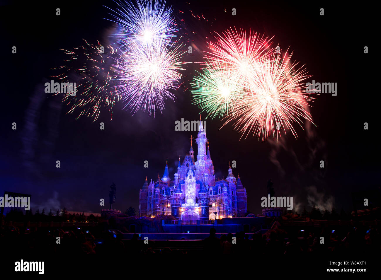 Fireworks explode over the Shanghai Disneyland at the Shanghai Disney ...