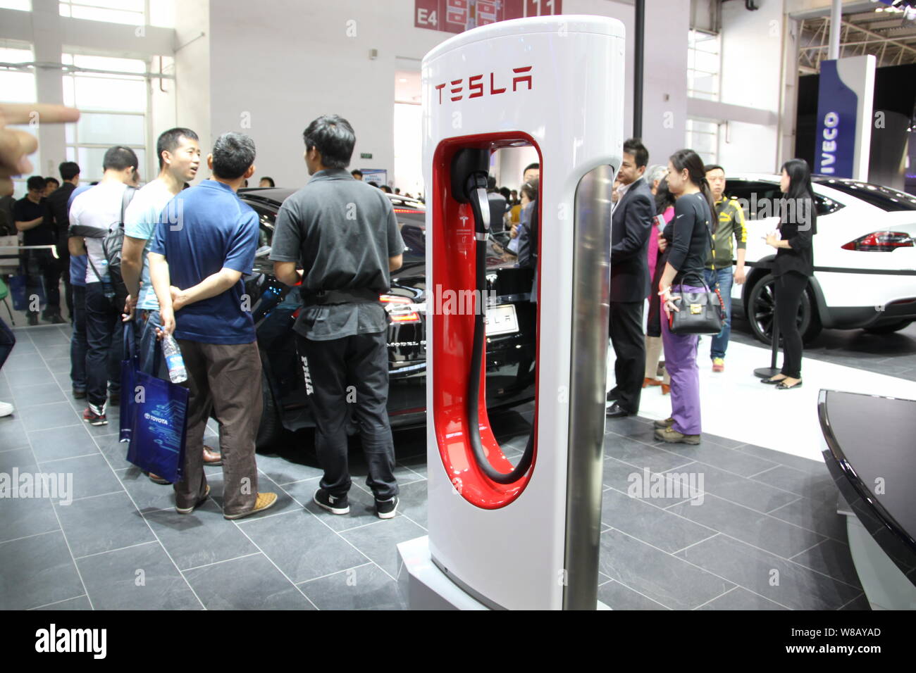 --FILE--People visit the stand of Tesla during the 14th Beijing ...