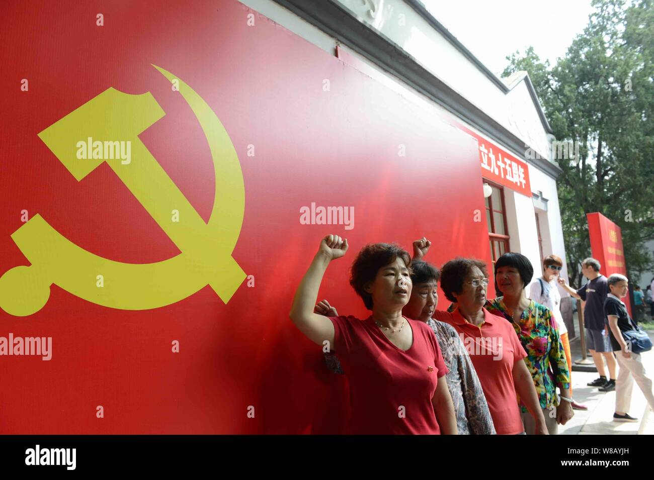 Chinese CPC (Communist Party of China) members swear in in front of a ...