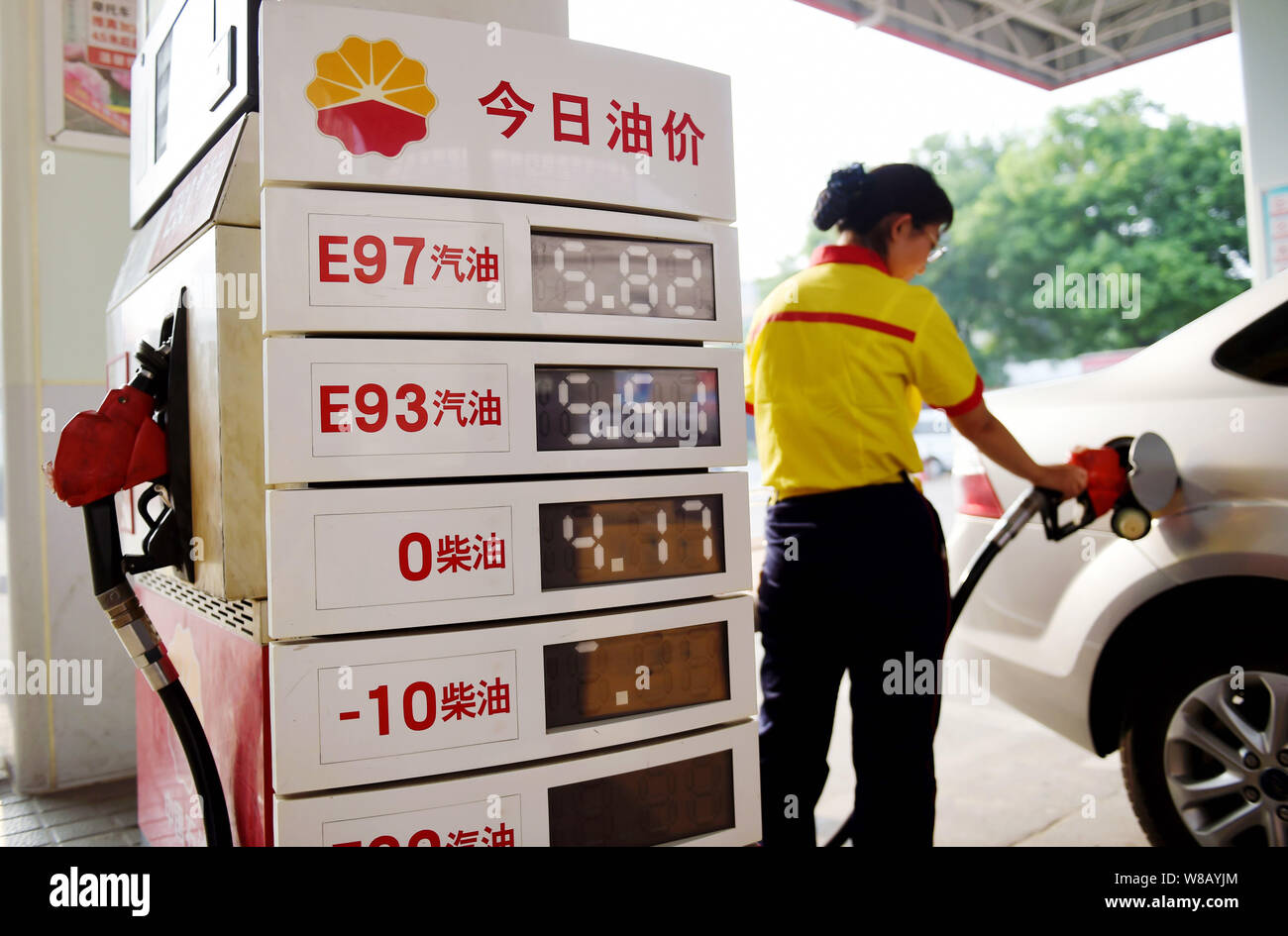 --FILE--A Chinese worker refuels a a car at a gas station of PetroChina, a subsidiary of CNPC ...