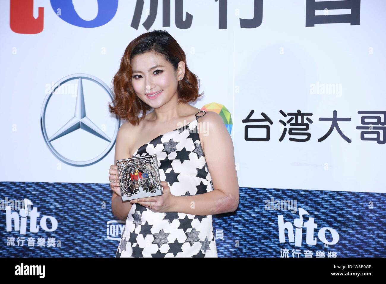 Ella Chen Chia-hwa of Taiwanese girl group S.H.E poses with her trophy ...