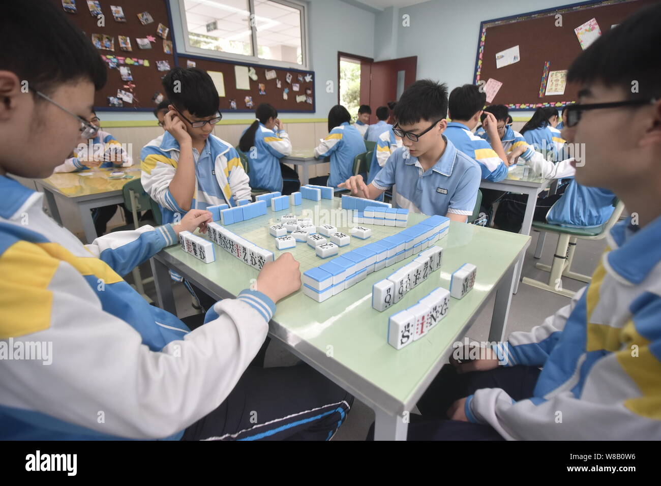 Young Chinese student play "English Mahjong" to learn English in the ...