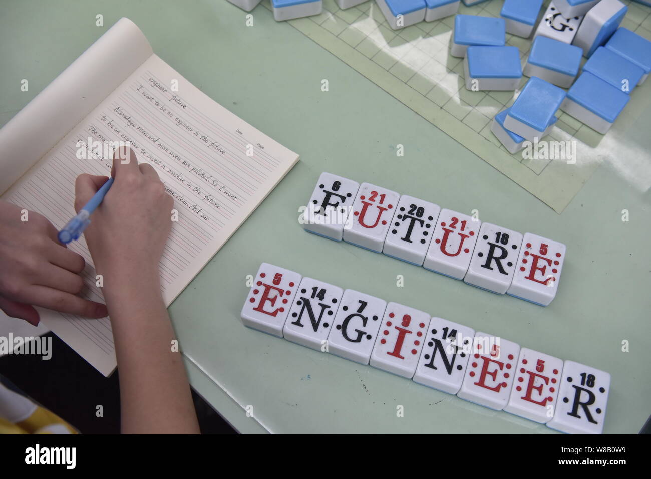 Young Chinese student play "English Mahjong" to learn English in the ...