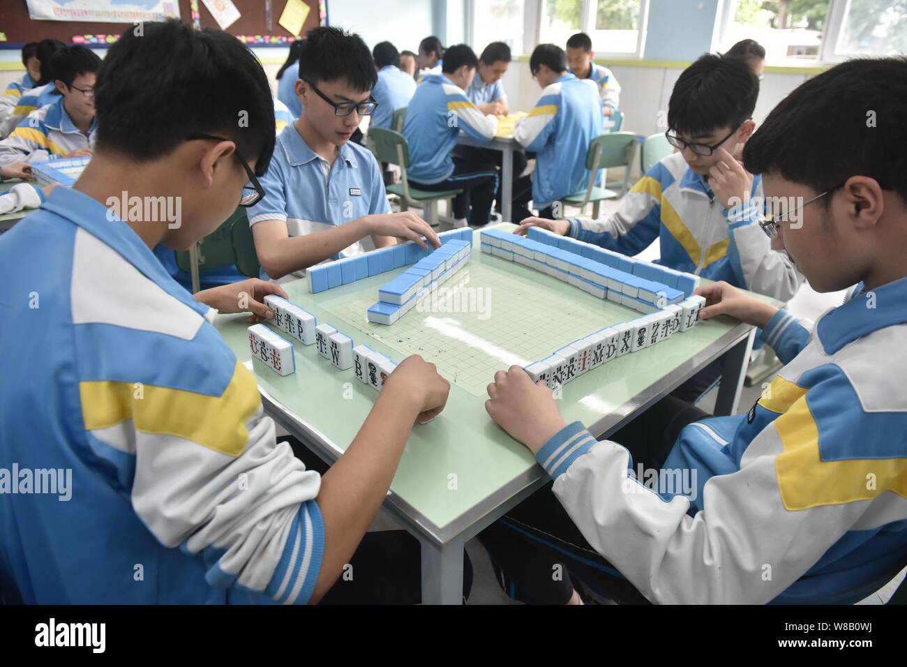 Young Chinese student play "English Mahjong" to learn English in the ...