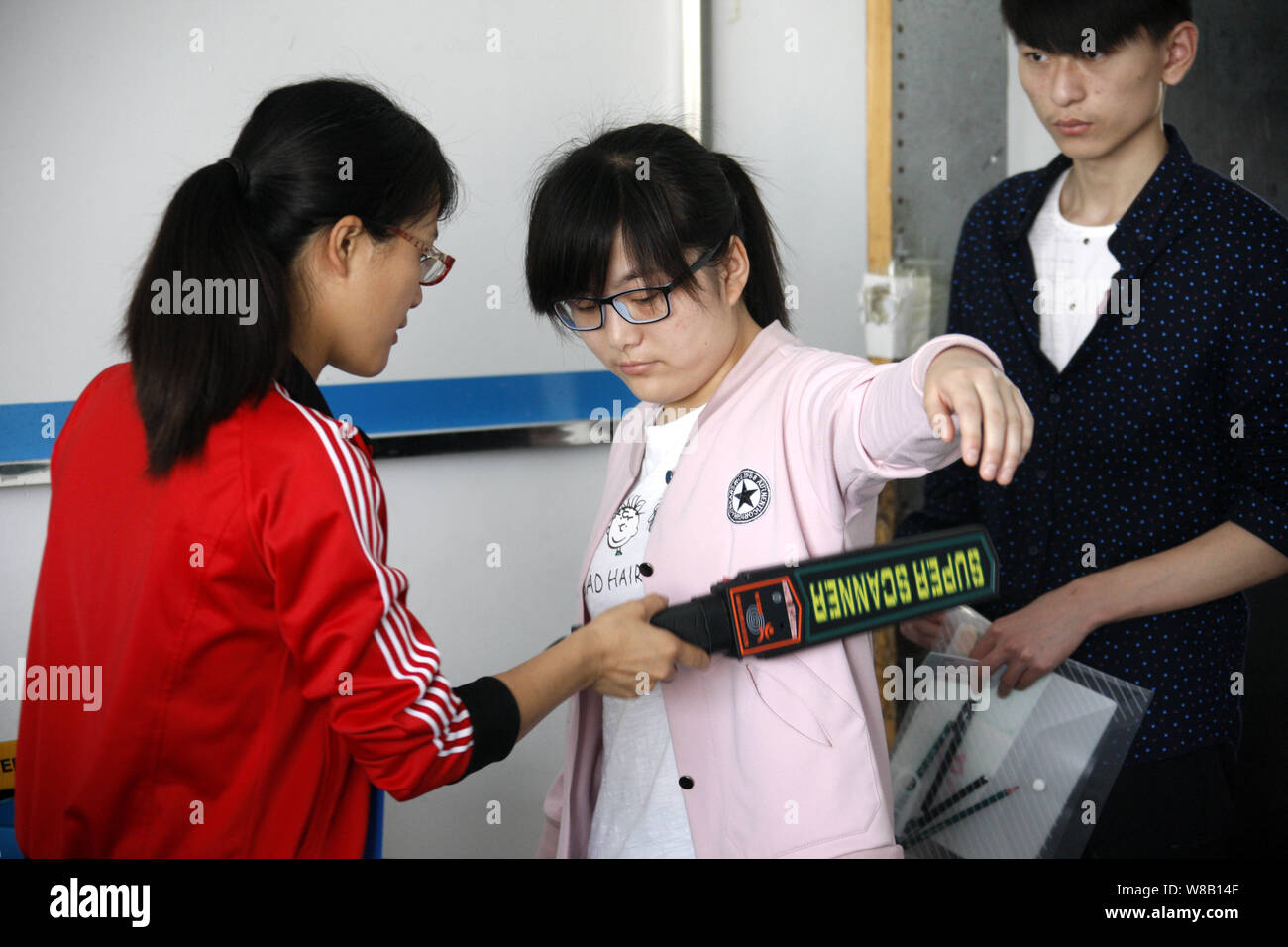 Chinese students receive security checks in the classroom before ...