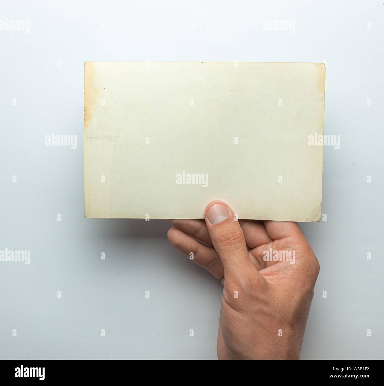 Old photo in the hands of man. Empty template for picture, mock-up ...