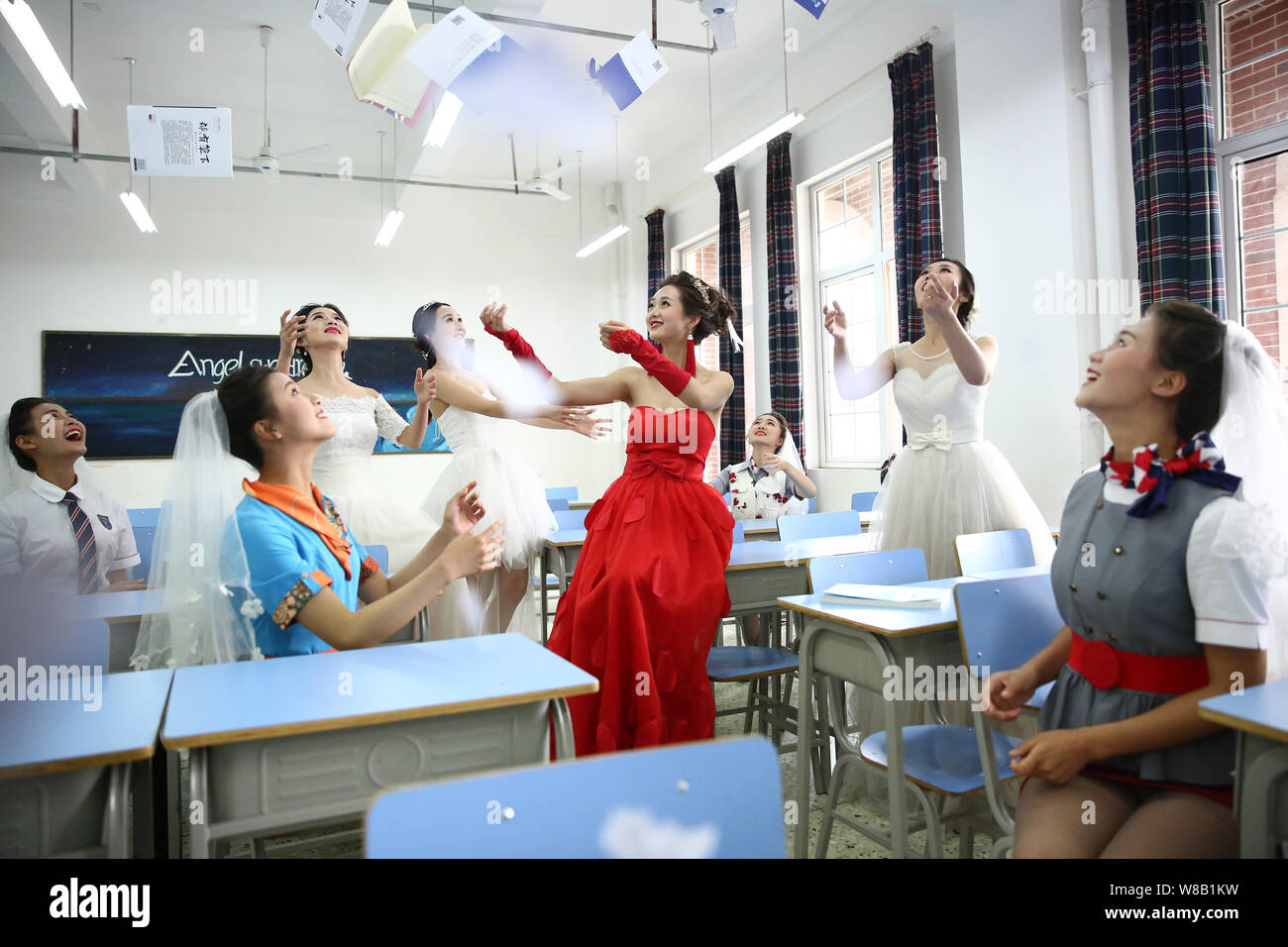 Female Chinese graduates dressed in wedding gowns pose for their ...