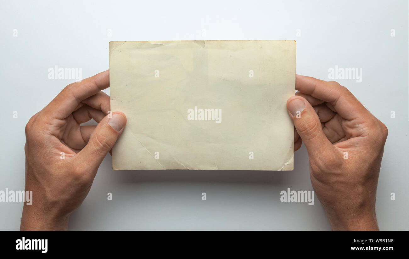 Old photo in the hands of man. Empty template for picture, mock-up ...