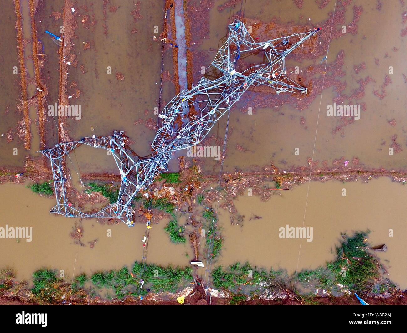 In this aerial view, Chinese technicians check a collapsed pylon ...