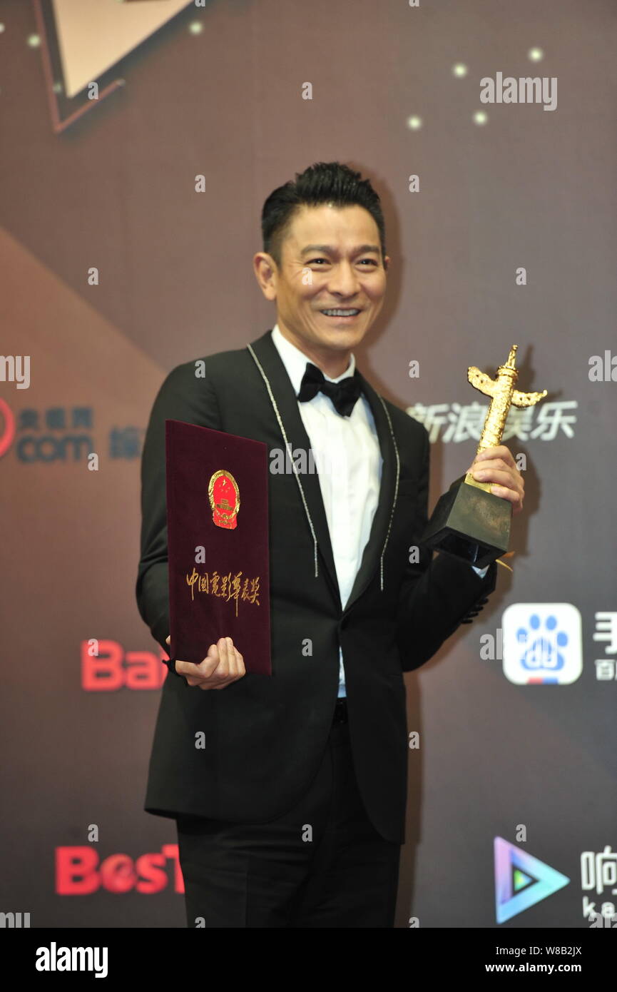 Hong Kong singer and actor Andy Lau poses with his trophy during the ...