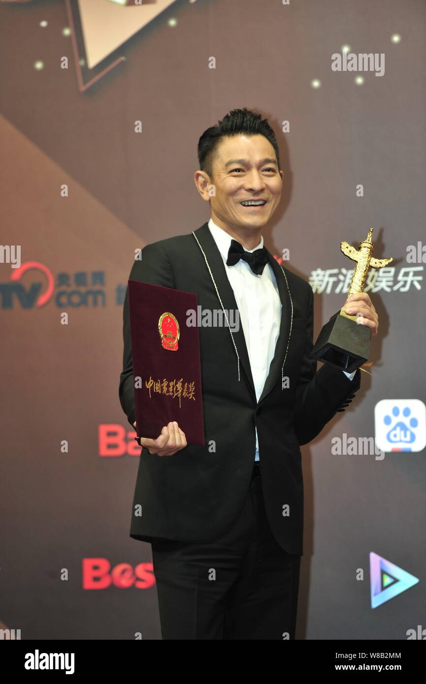 Hong Kong singer and actor Andy Lau poses with his trophy during the ...