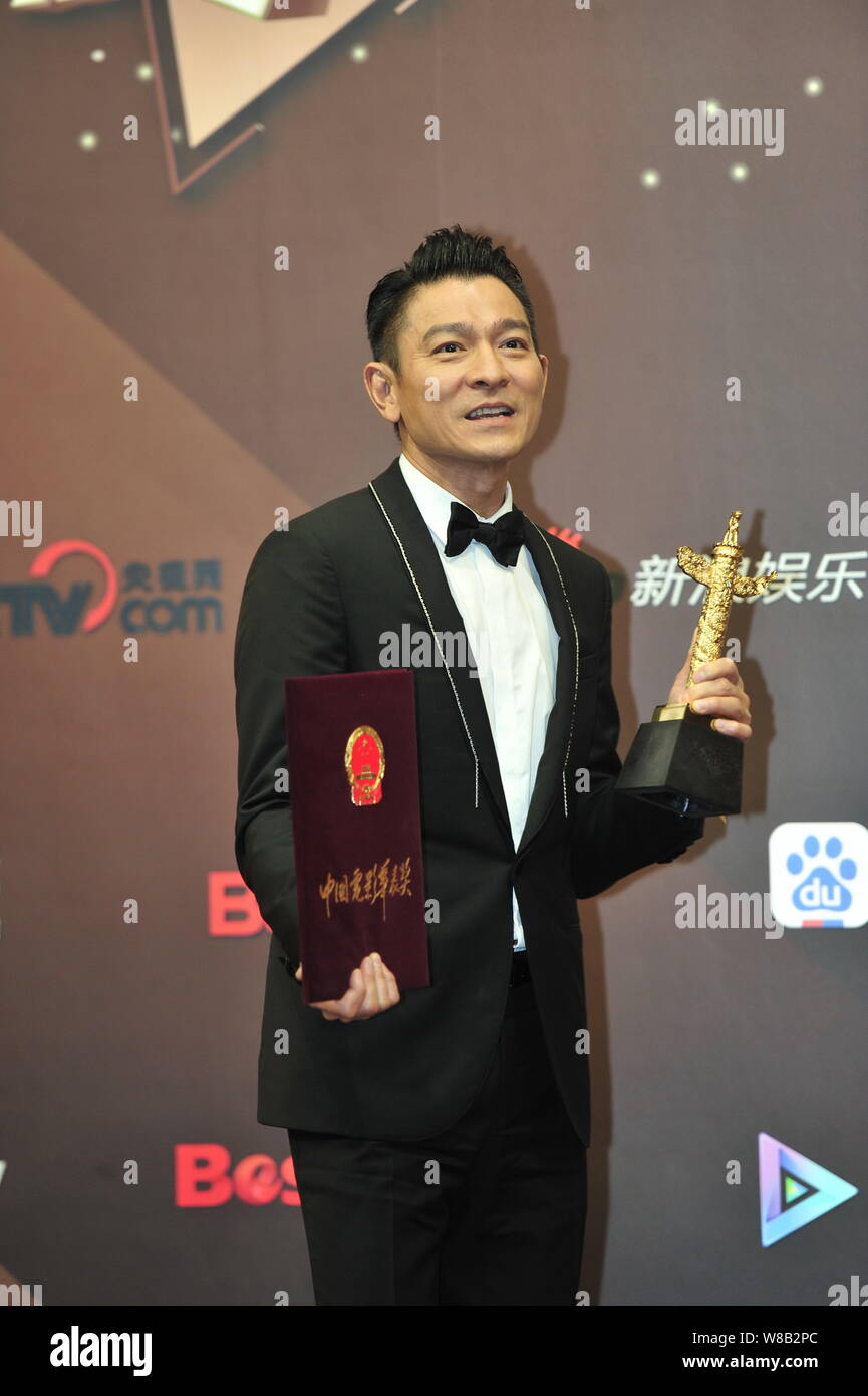 Hong Kong singer and actor Andy Lau poses with his trophy during the ...
