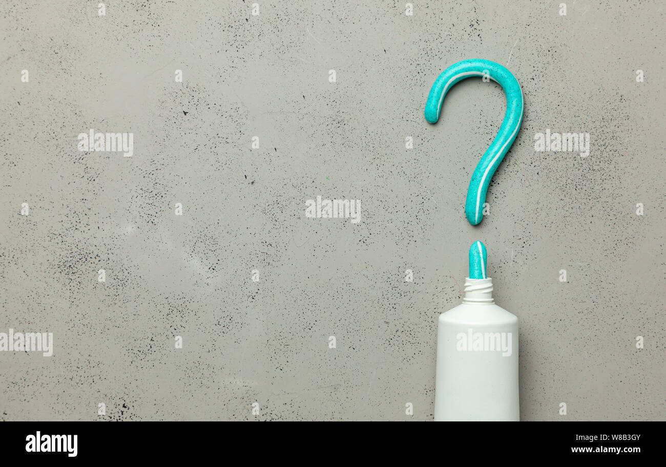 Toothpaste in the shape of a question mark. Concept of how to choose a ...