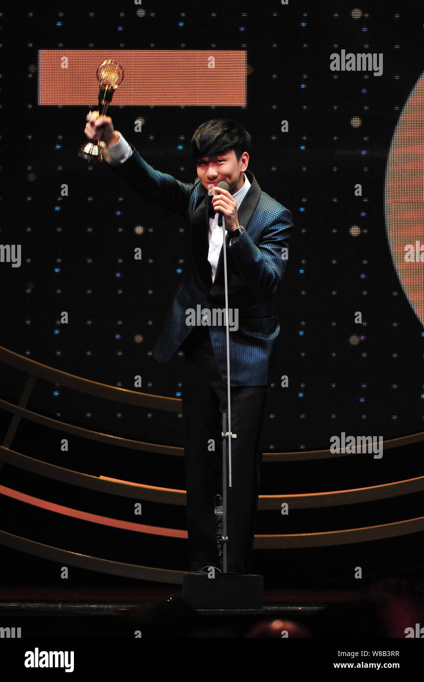Singaporean singer JJ Lin holds up his trophy for the Best Male ...