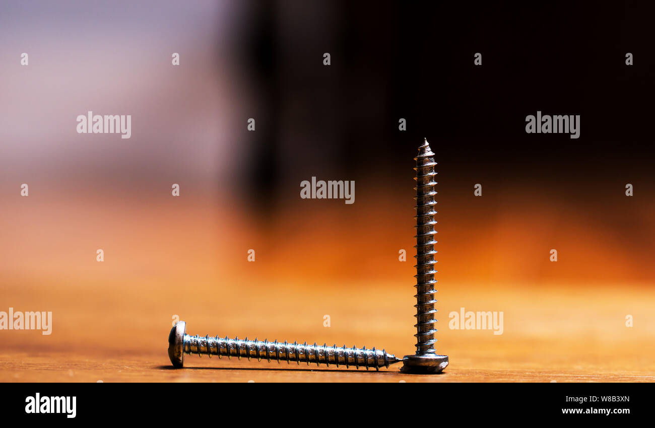 Long neck standing screws on wooden background hi-res stock photography ...