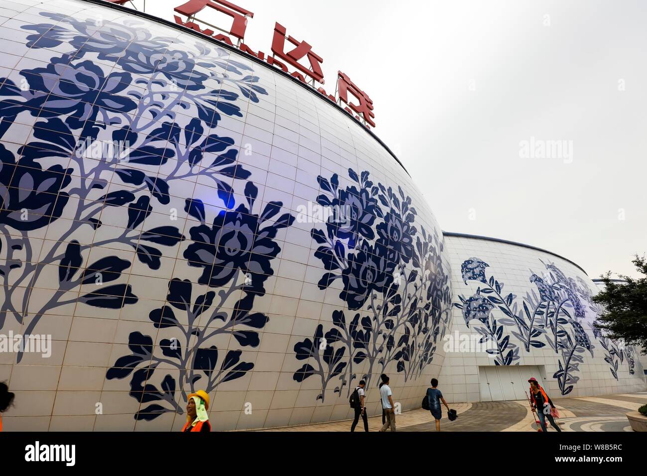 People walk past the Wanda Mall at the Nanchang Wanda Cultural Tourism ...