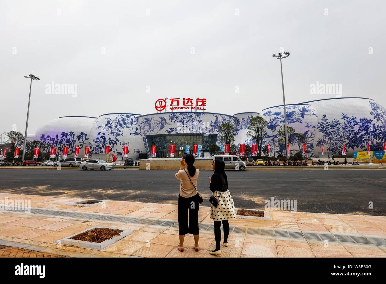 People take pictures of the Wanda Mall at the Nanchang Wanda Cultural ...