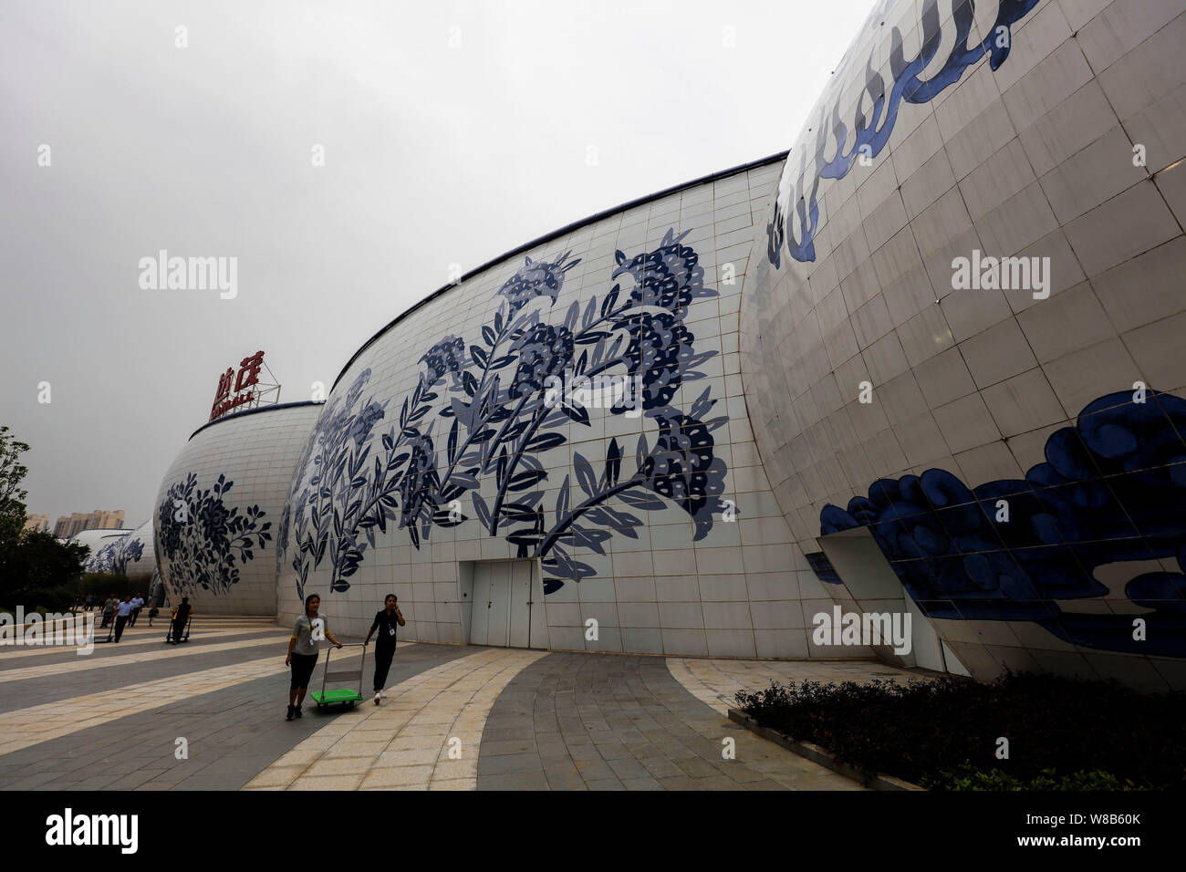 People walk past the Wanda Mall at the Nanchang Wanda Cultural Tourism ...
