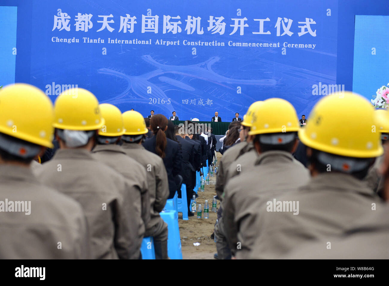 Chinese officials and workers attend the construction commencement ...