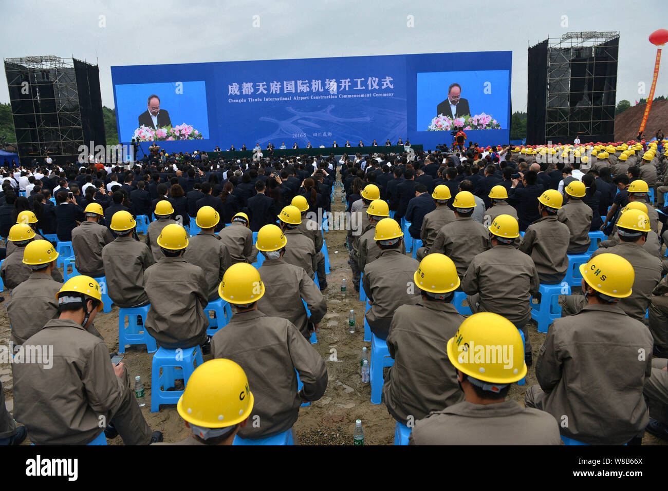 Chinese officials and workers attend the construction commencement ...