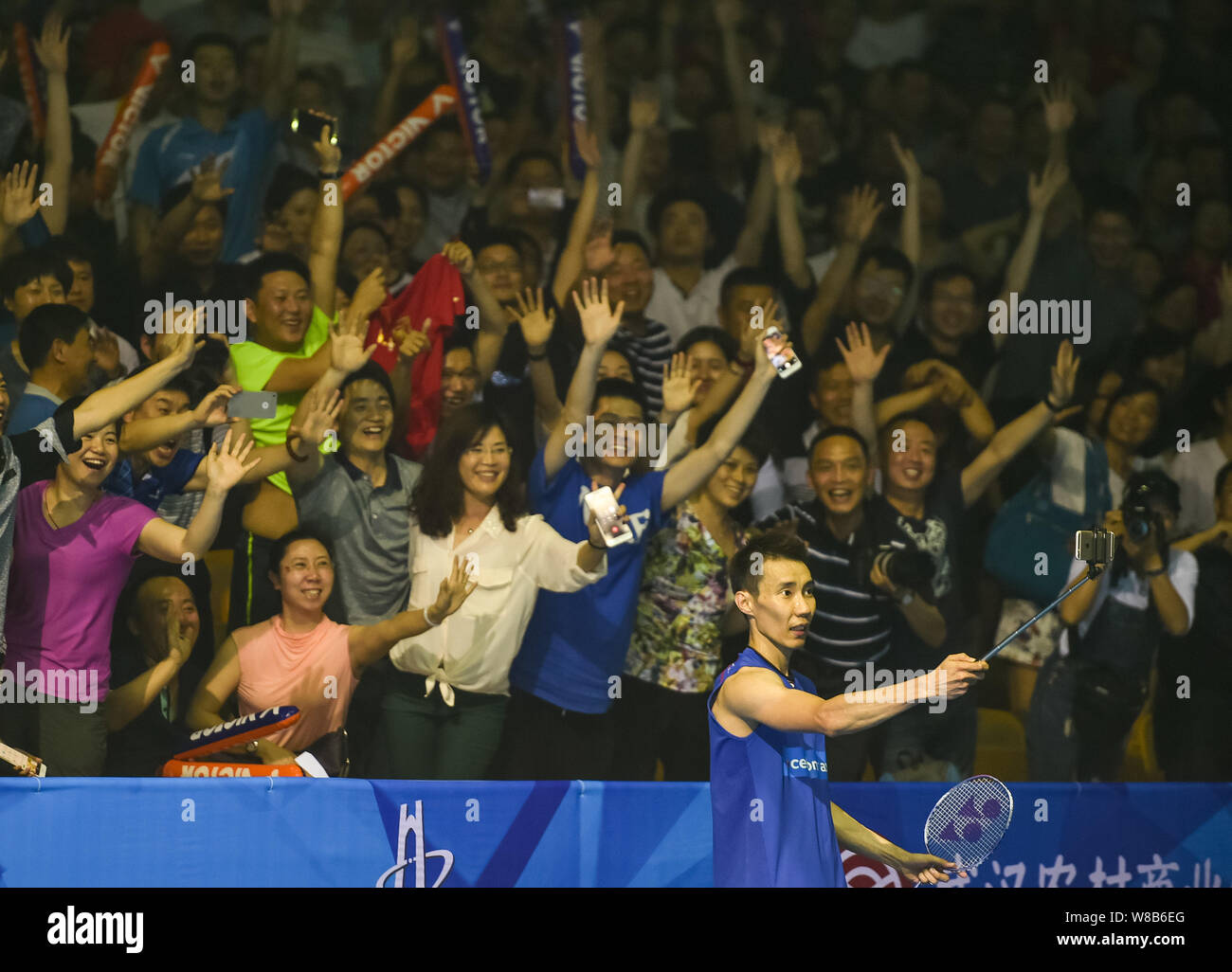 Datuk Lee Chong Wei of Malaysia, front, takes a selfie with fans after ...