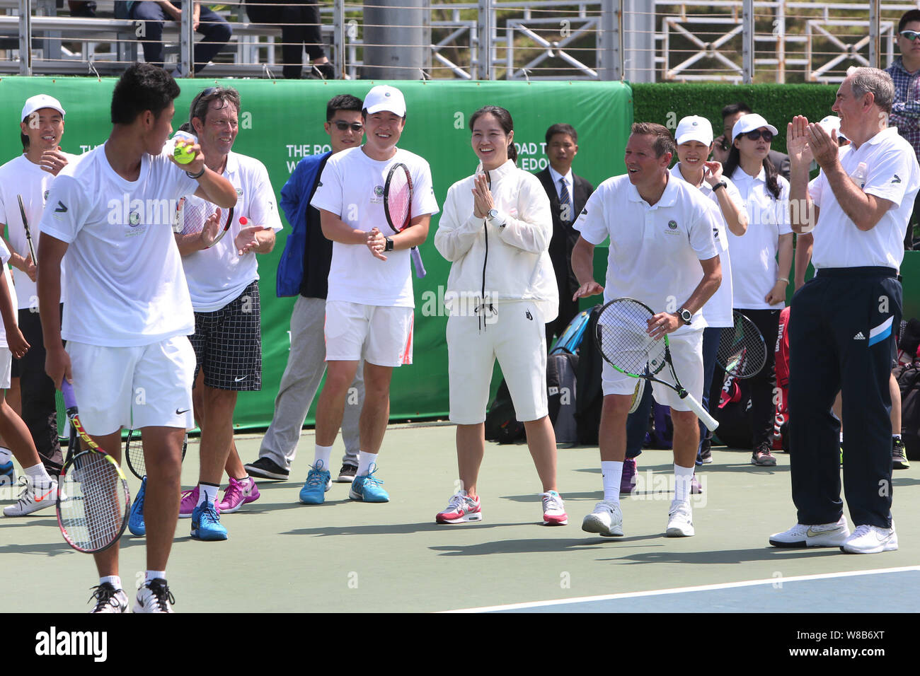 Retired Chinese tennis player Li Na, front third right, watches young ...