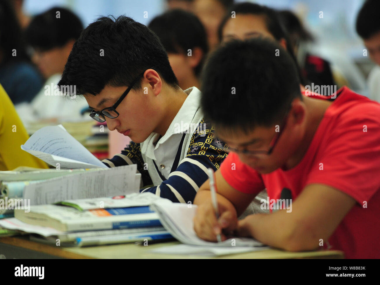 Chinese students review textbooks in preparation for the upcoming ...