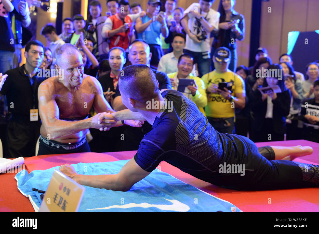 US Navy veteran George Hood, back, shakes hands with Mao Weidong, front ...