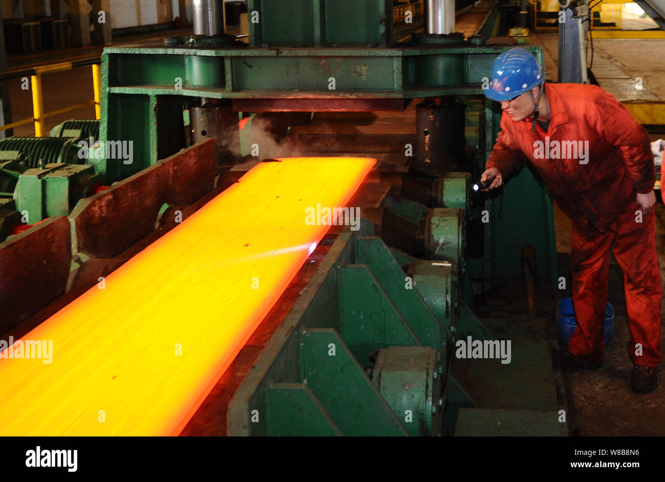 --FILE--A Chinese worker checks a steel product at a plant of Dongbei ...
