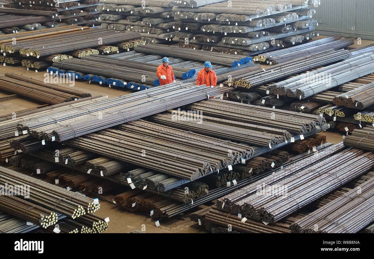 --FILE--Chinese workers check steel products in the warehouse at a ...