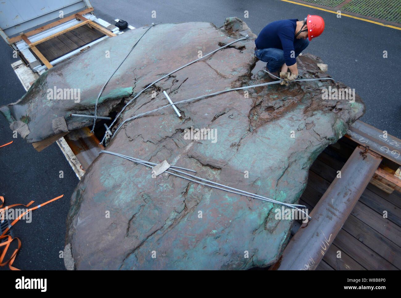 A Chinese worker removes tightwire from the world's largest piece of ...