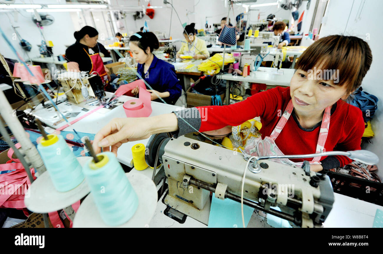 --FILE--Female Chinese workers sew sachets to be exported to South Korea at a factory in Dexing ...