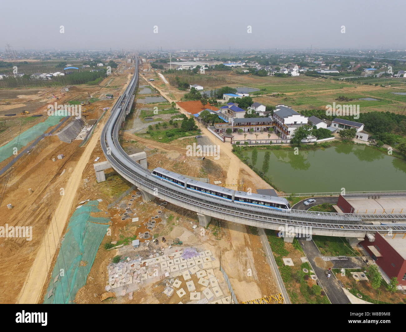 A maglev train travels on the track of China's first home-developed low ...