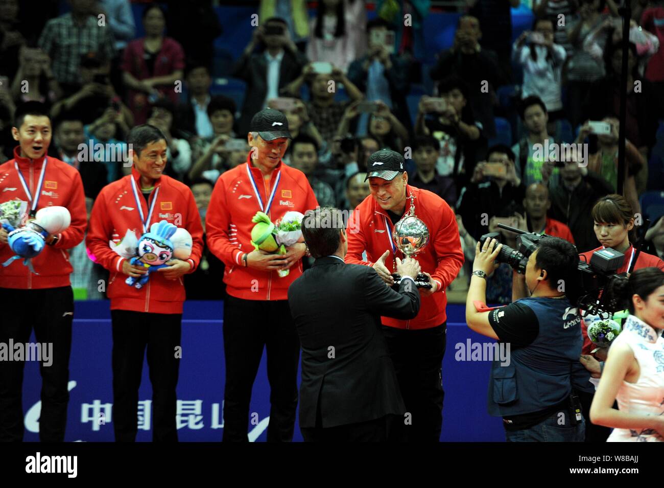 Head coach Li Yongbo of China, fourth left, receives the champion ...