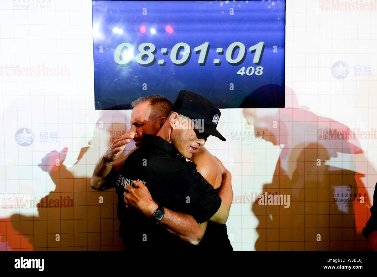 US Navy veteran George Hood, right, hugs Mao Weidong, a member of a ...