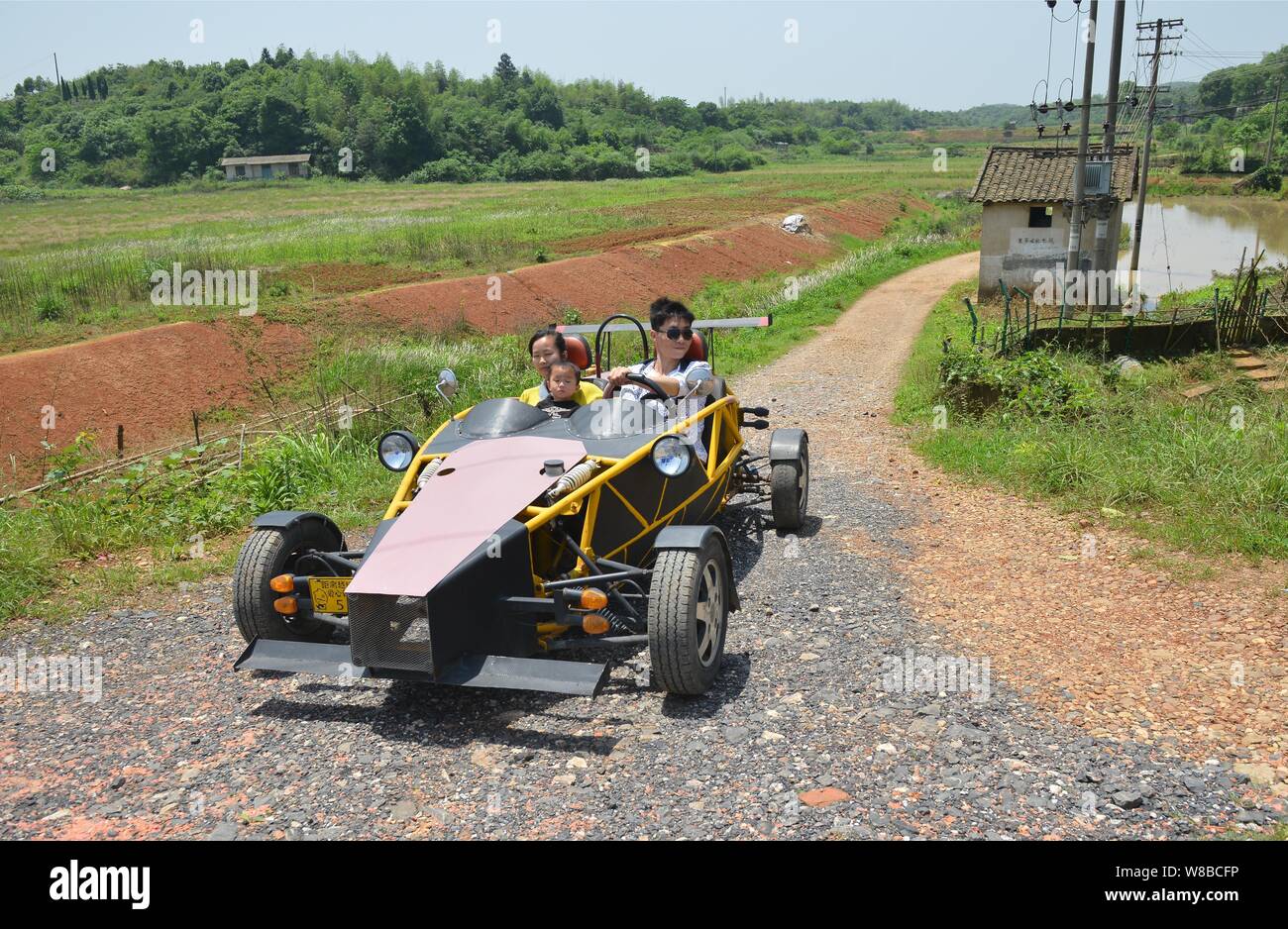 Chinese car repairman Wen Chao, right, test-drives his homemade sports ...