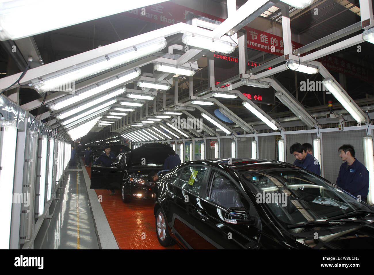 --FILE--Chinese workers assemble Geely Emgrand cars on the assembly ...