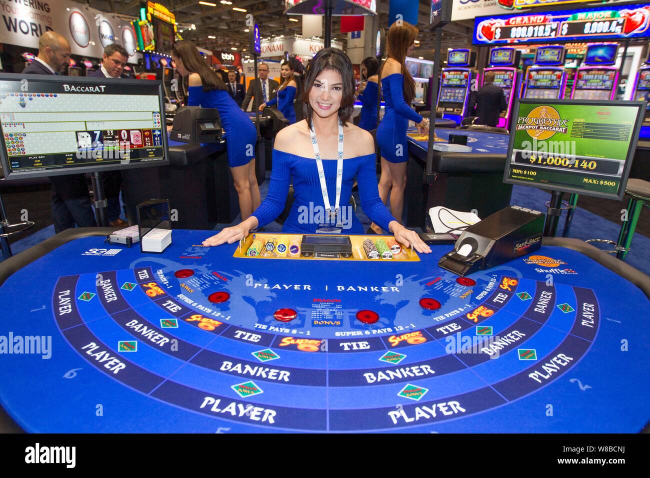A croupier sits at a gaming table during the Global Gaming Expo Asia ...