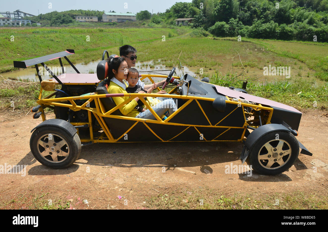Chinese car repairman Wen Chao, back, test-drives his homemade sports ...