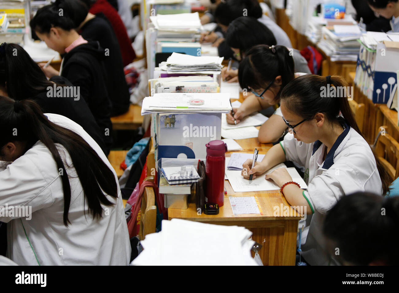 Chinese students review textbooks in preparation for the upcoming ...