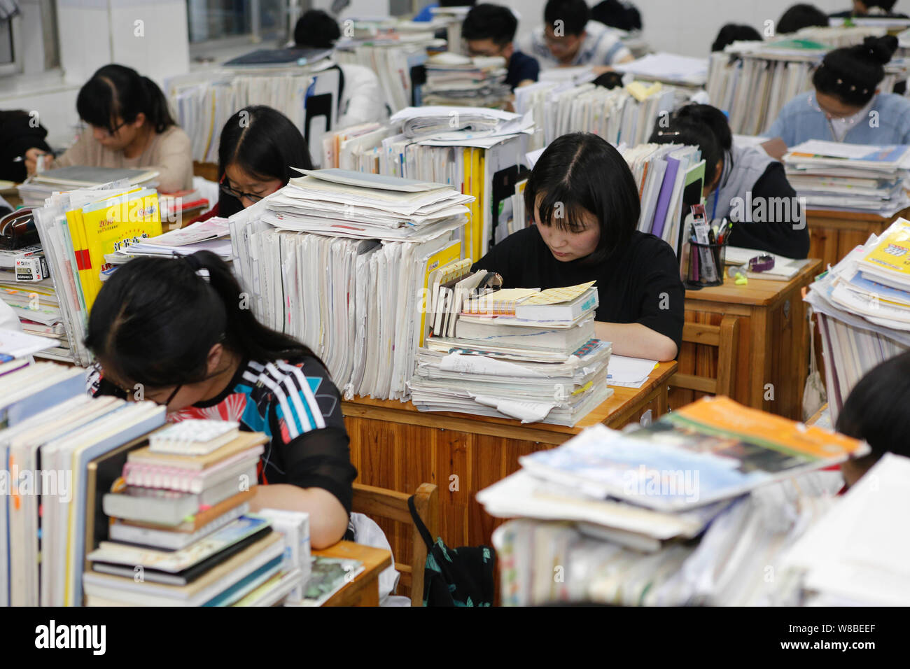 Chinese students review textbooks in preparation for the upcoming ...