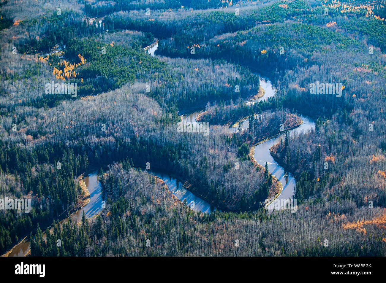 A winding river in the oil sands area near Fort McMurray, Alberta ...