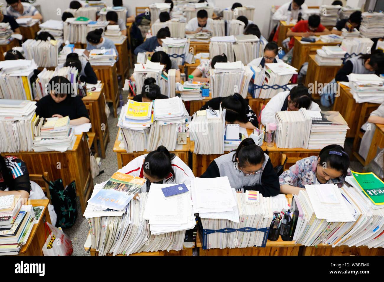Chinese students review textbooks in preparation for the upcoming ...
