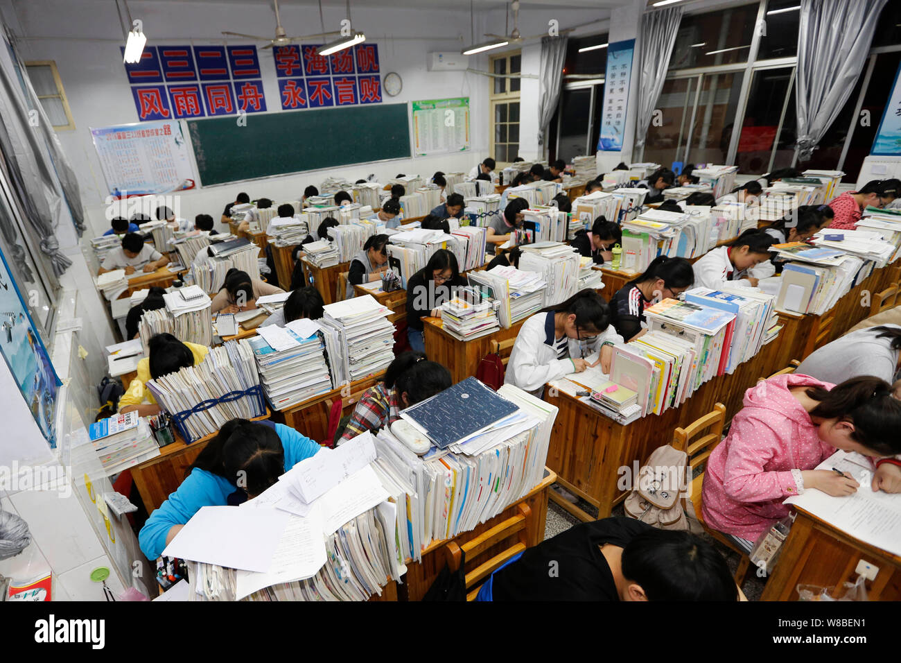 Chinese students review textbooks in preparation for the upcoming ...