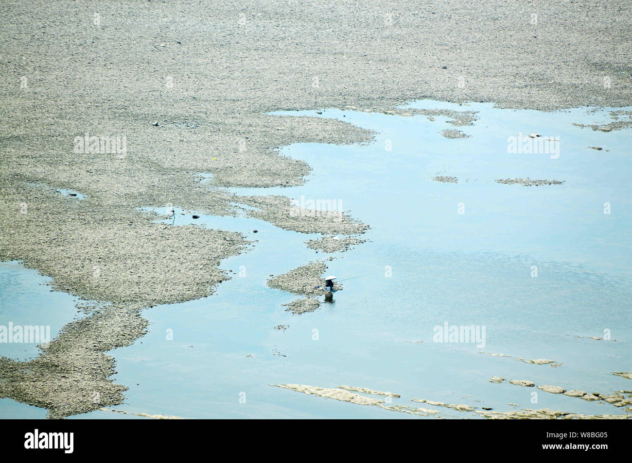 View of the exposed riverbed as water levels dropped on the ...