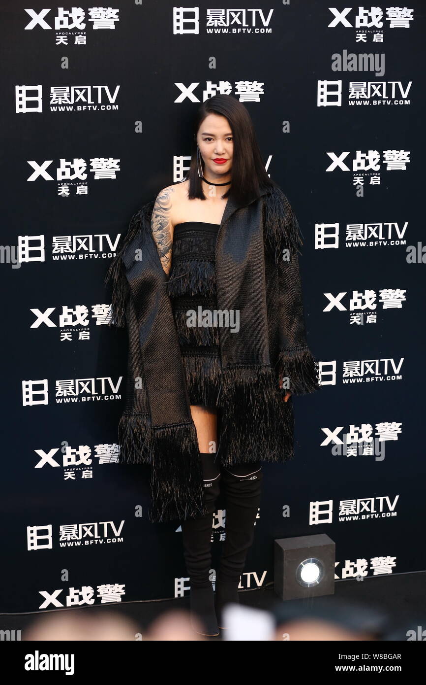 Chinese singer Tan Weiwei arrives for a premiere event of the movie "X ...