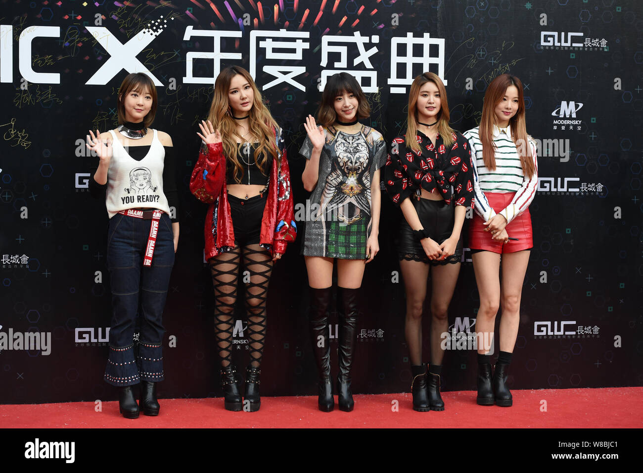 Members of South Korean girl group EXID pose on the red carpet as they ...