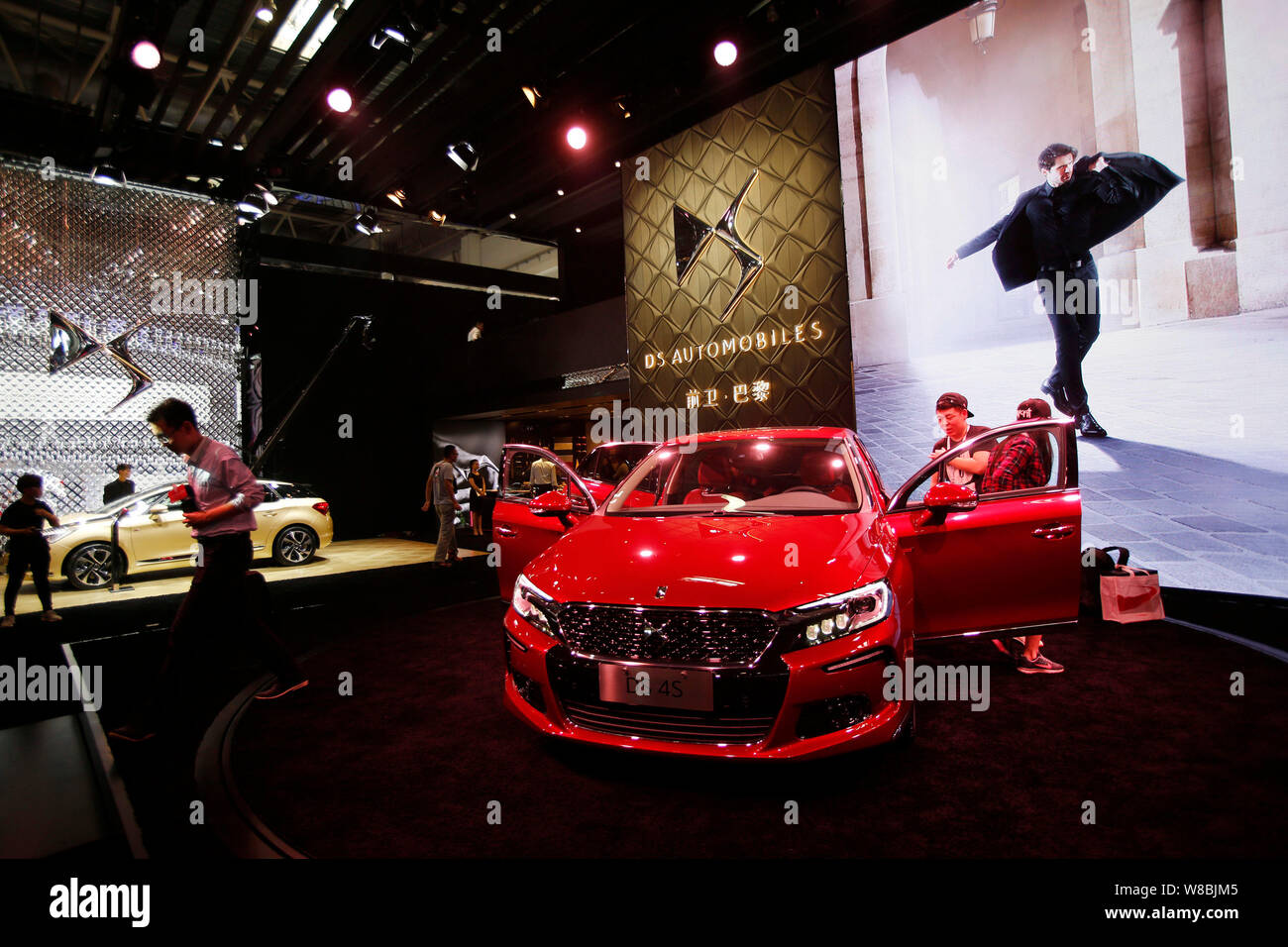 Visitors try out a DS 4S of PSA on display during the 14th Beijing International Automotive ...