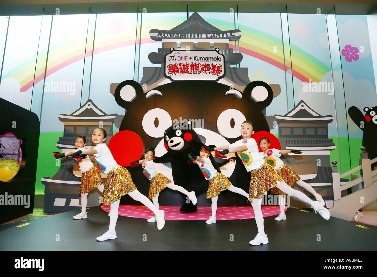 In this handout picture, young girls and an entertainer dressed in the ...